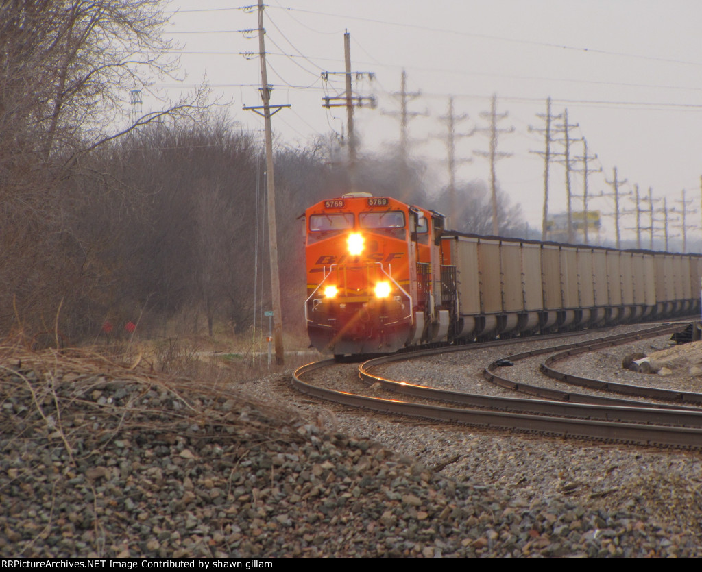 BNSF 5769 swings the curve with a load of coal.